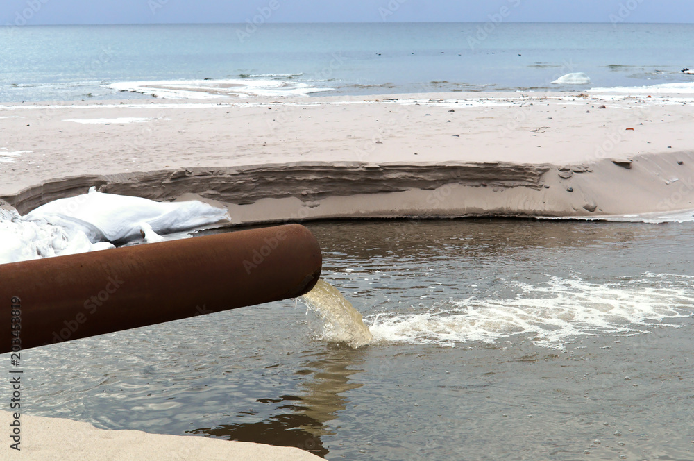 Sewer pipe into the sea. The dirty drain waste water. Environmental ...