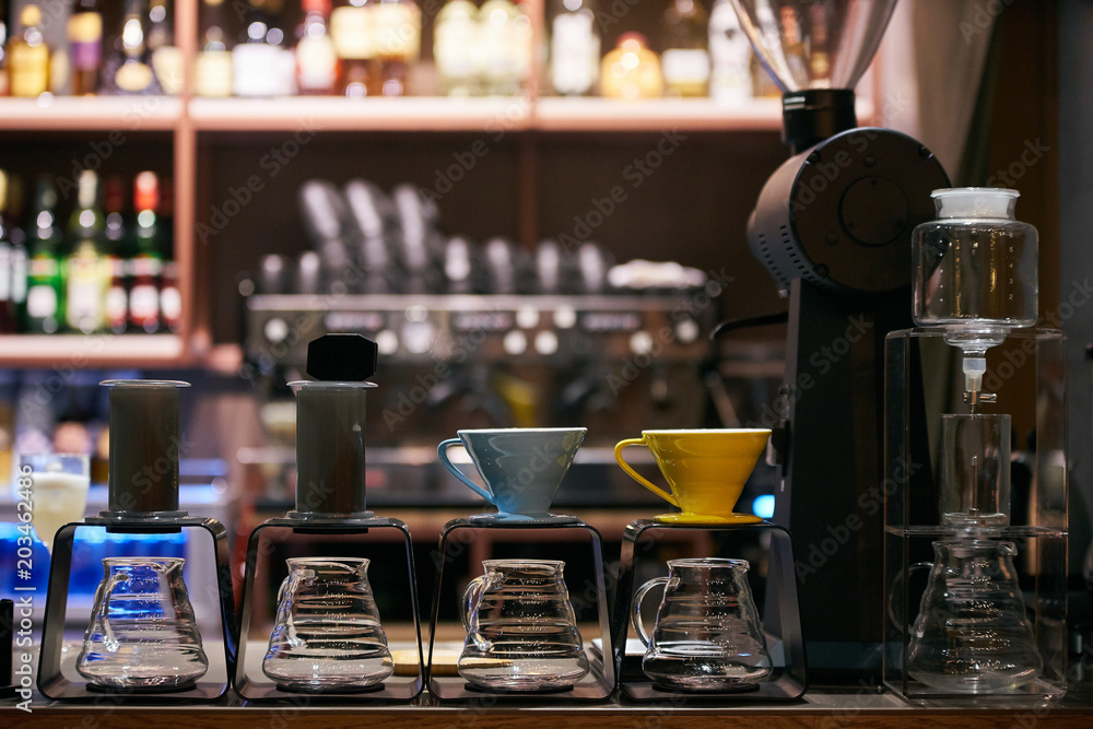 Coffee machine and glassware in coffee shop with bar shelves on ...