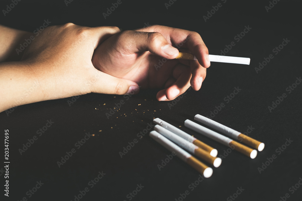 Girl touching habitual smoker hand. Stop cigarette addiction by ...