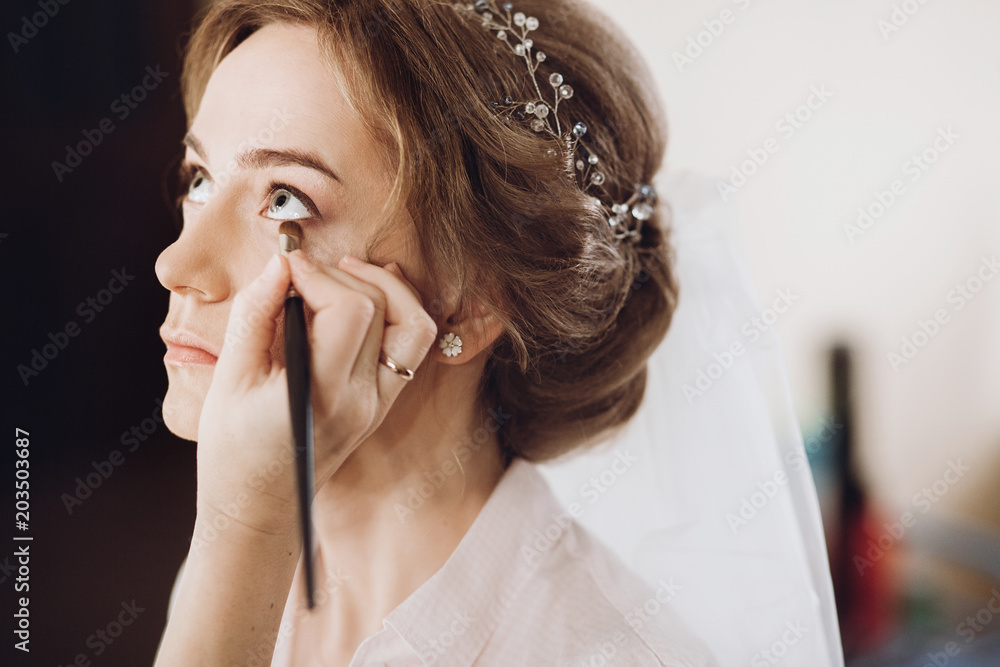make up. bride getting on her make-up on by professional artist ...