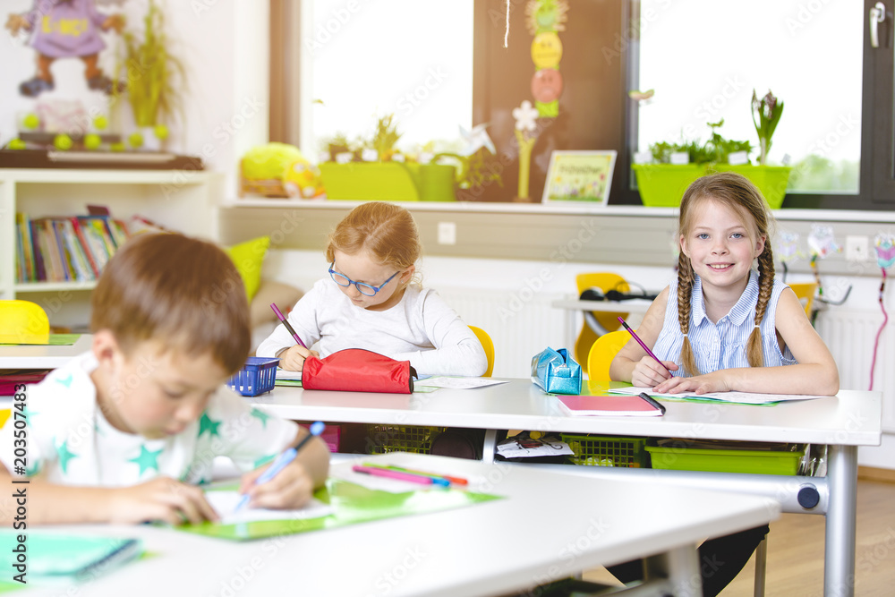 At School - Beautiful young kids have fun in school while learning in ...