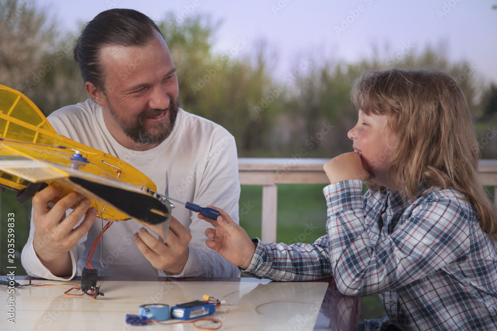 son and father made homemade radio-controlled model aircraft (airplane ...
