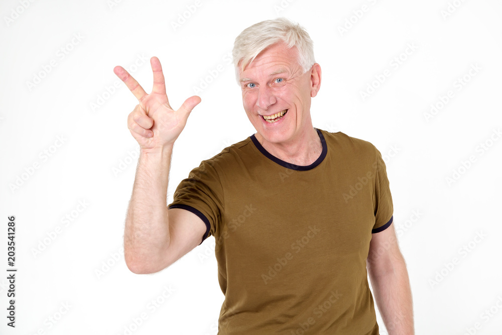Adult man with gray hair shows thumbs up digit three standing isolated ...