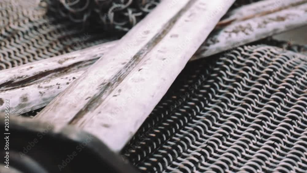 Crossed swords on chain armor, close up, historical ancient weapon ...