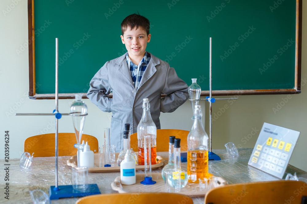 Cute boy is making science experiments in a school laboratory Stock ...
