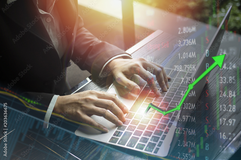 Investing on laptop and stock market concept gain with profits and ...