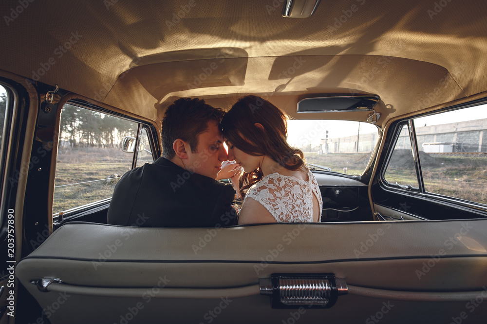 Young Wedding Couple Sitting Smiling Inside Retro Car Just Married