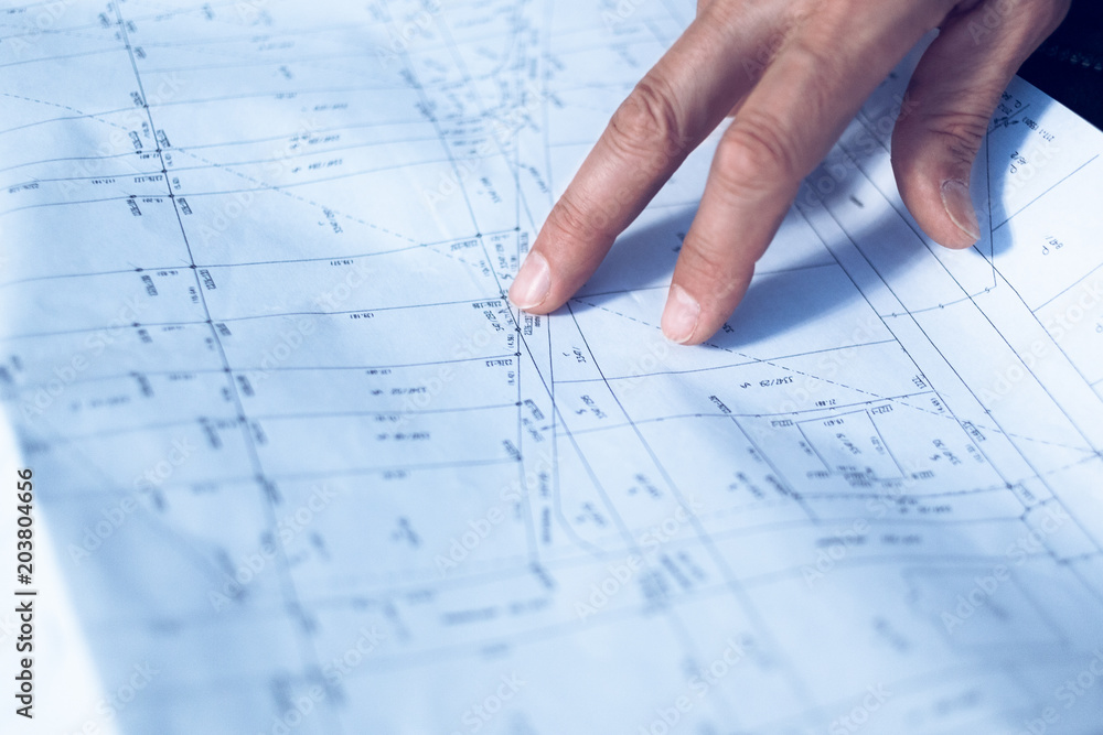 Drawing with distribution of land, Man presents project, Construction ...