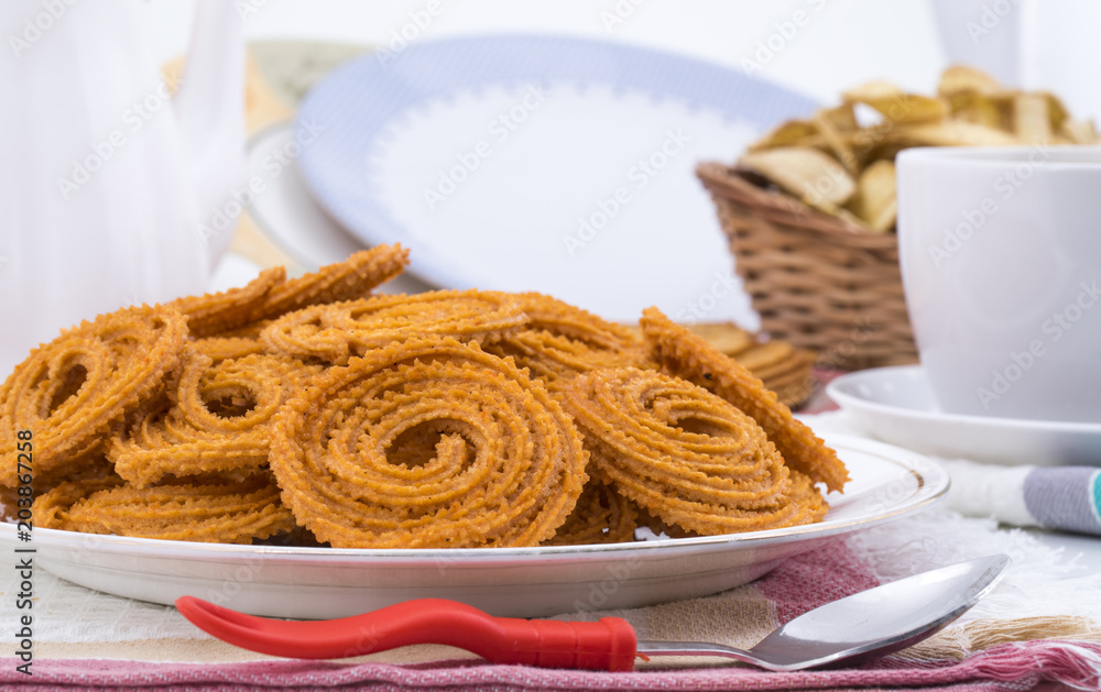 Indian Traditional Snack Chakli, a spiral shaped crisp deep fried snack ...