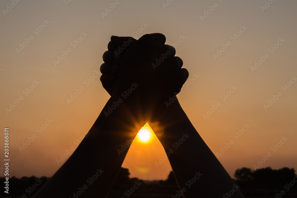silhouette of couple holding hands up celebrating victory beautiful ...