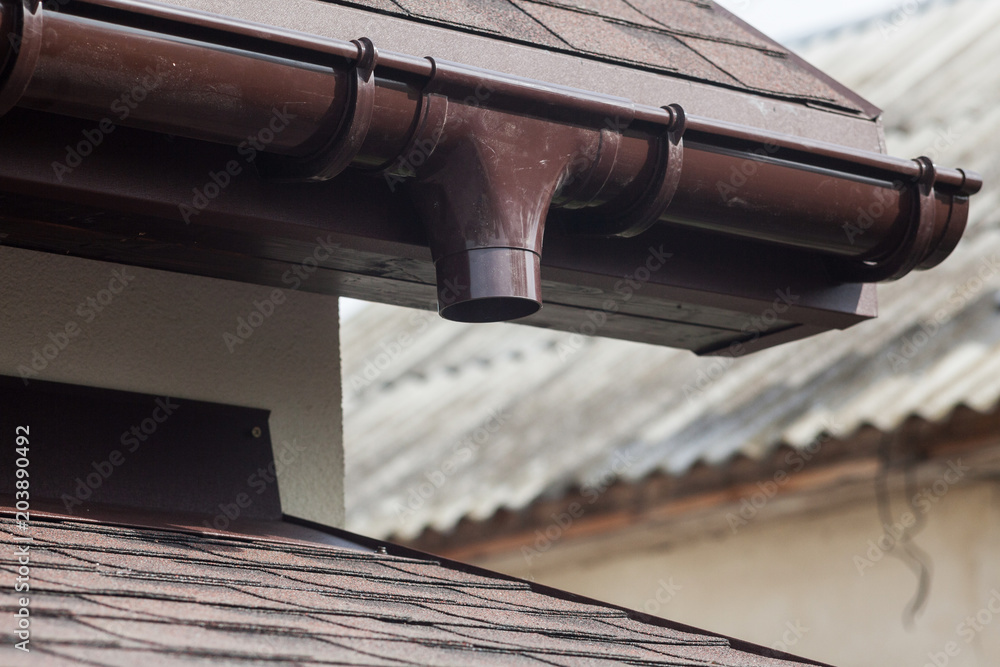 Roof under construction with new asphalt tile and rain gutter Stock ...
