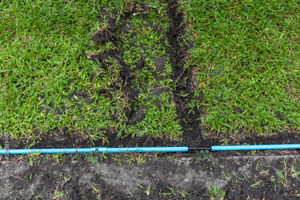 installation of electric wire or cable on ground, blue plastic pipe for ...