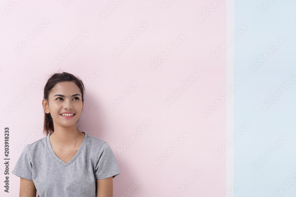 The beauty lady is standind at the left side of pastel background,with ...