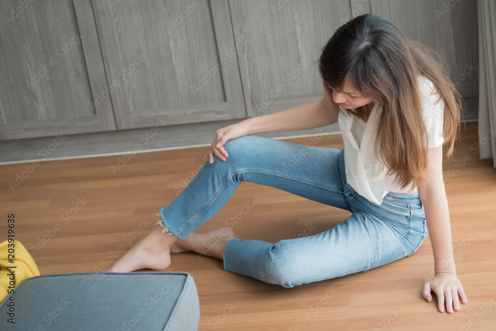injured woman with broken knee or leg pain; portrait of asian woman ...