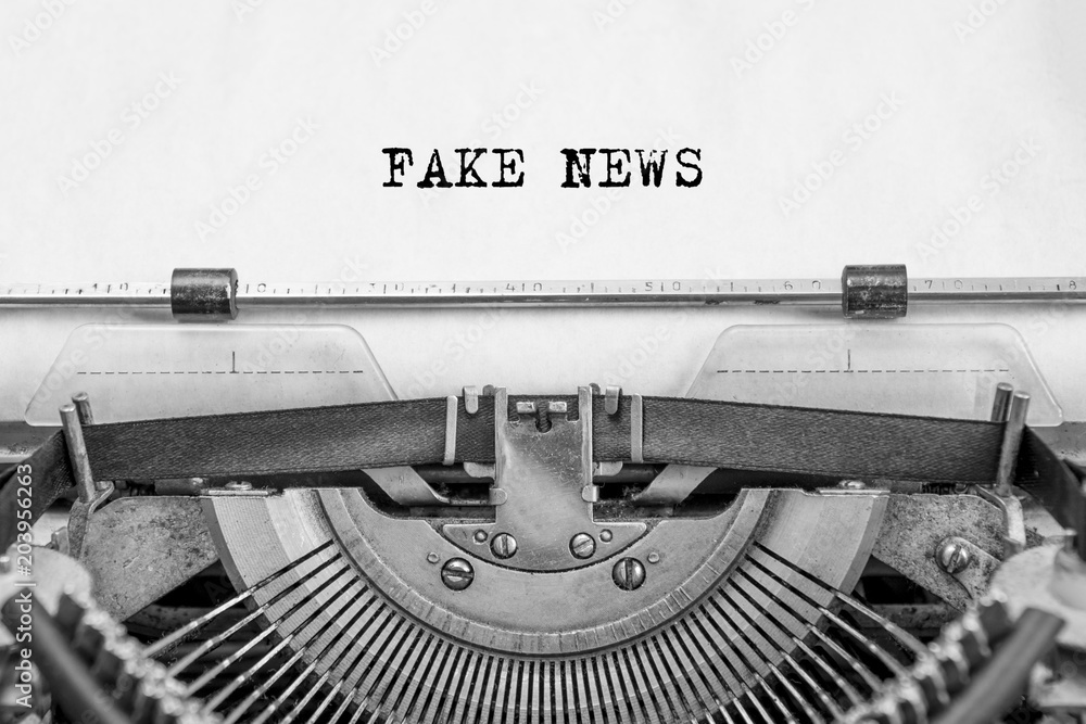 text FAKE NEWS is typed on old paper by a vintage typewriter Stock ...