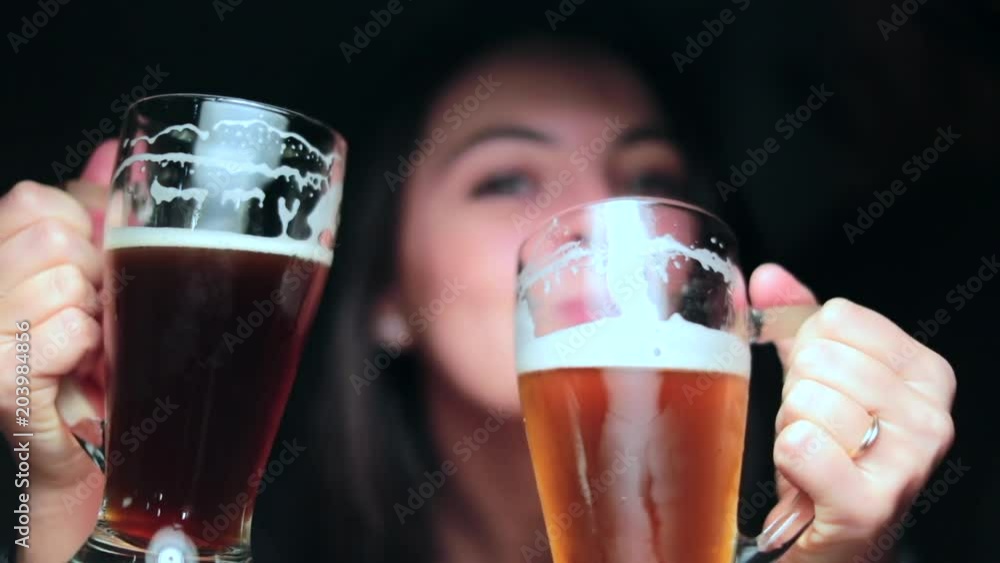 Woman acting silly celebrating with draft beers toasting herself ...