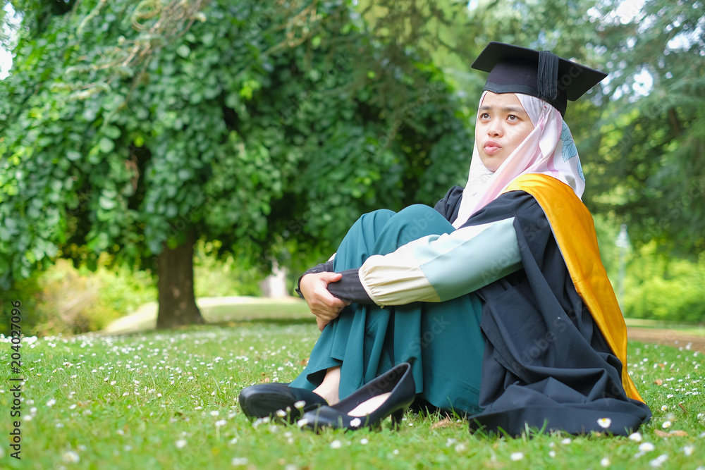 Beautiful female Muslim wearing a convocation robe and posed in ...