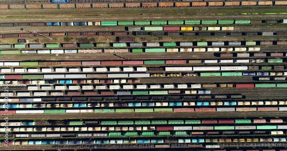AERIAL. Camera zooming and rotation. Cargo trains close-up. Aerial view ...