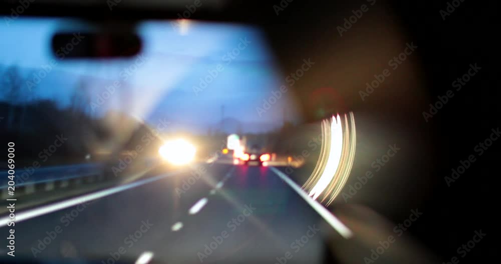 Front of the bus perspective driving at night on the road with lens ...