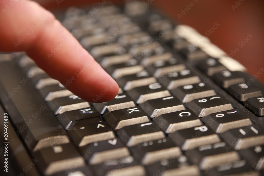Closeup of Man's Finger Almost Touching the Letter K Key on Black ...