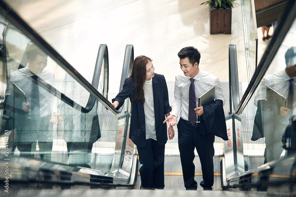 Business people talking in the elevator Stock Photo | Adobe Stock