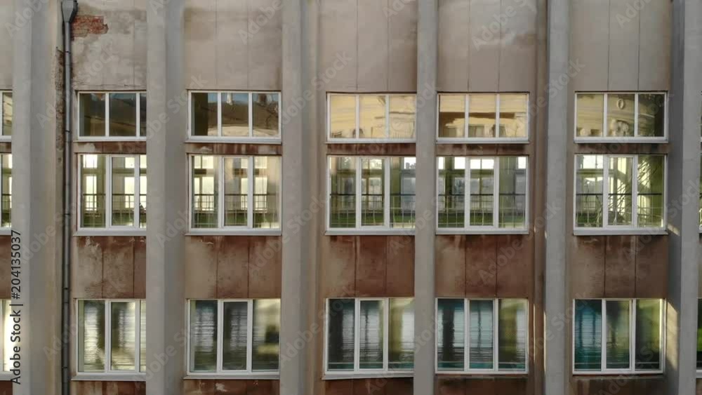 Reflections in large windows with white frames on a monumental building ...