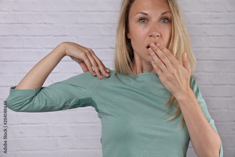 Woman armpit sweating. Transpiration stain. Hyperthyroidism concept ...