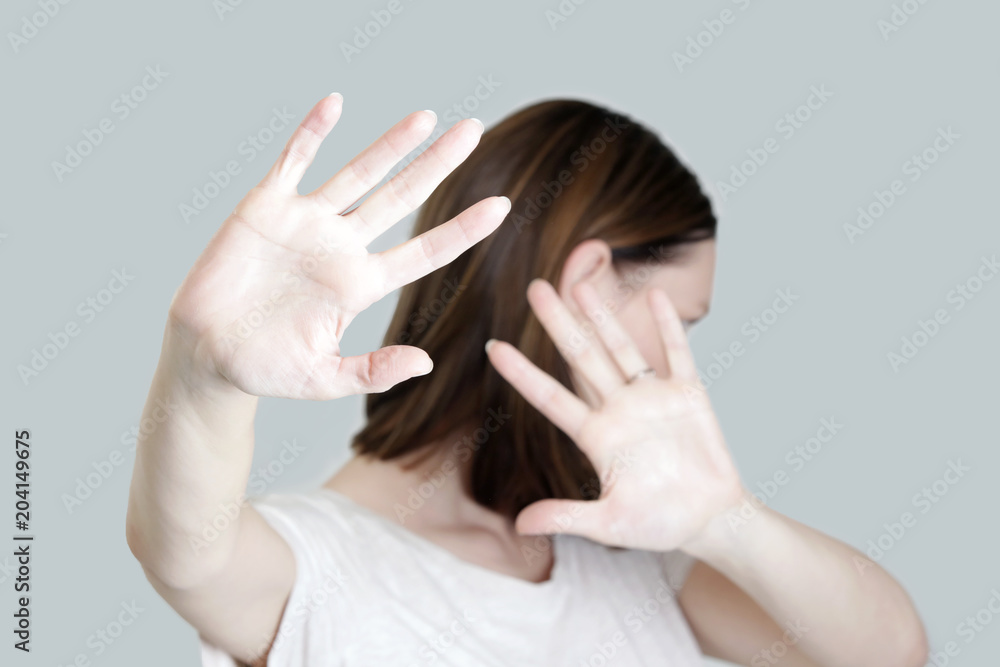 Self defense, studio portrait of scared woman raising hands up in ...