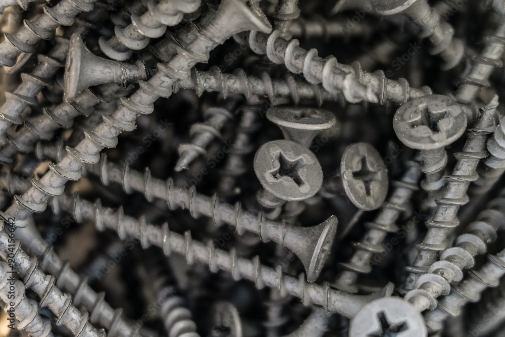 Black metal screws in set. Fasteners with anti-corrosion coating close ...