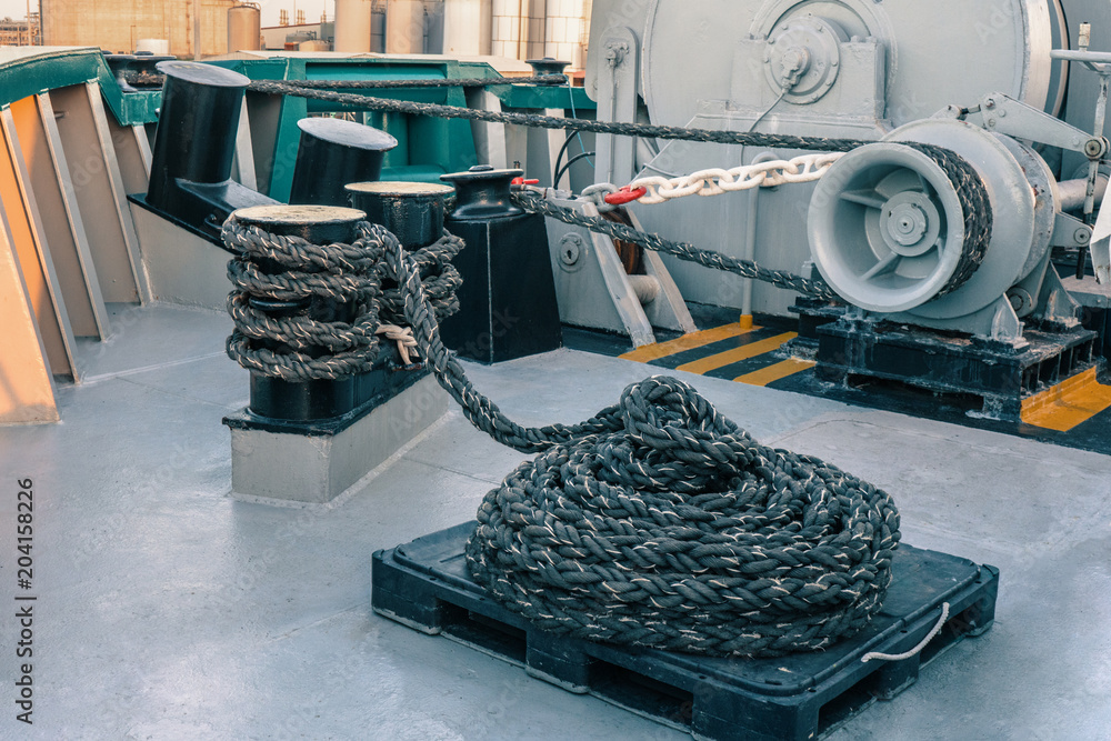 mooring equipment of ship. Mooring lines are fast on bollards, capstan ...