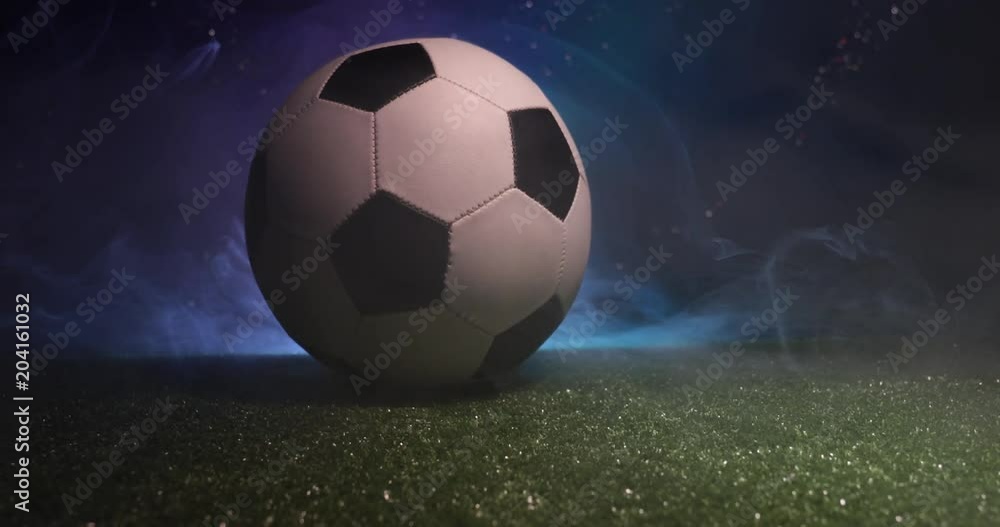 Slider shot. Traditional soccer ball on soccer field. Close up view of ...