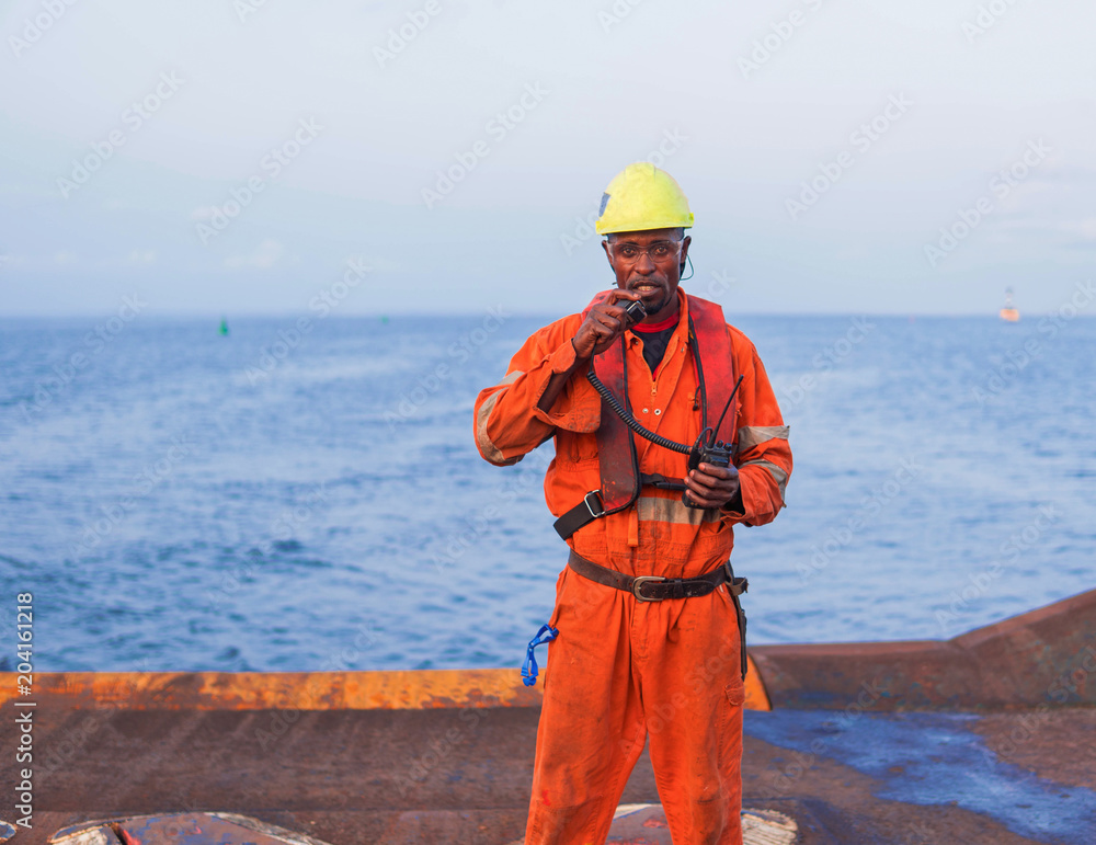 Seaman AB or Bosun on deck of offshore vessel or ship , wearing PPE ...
