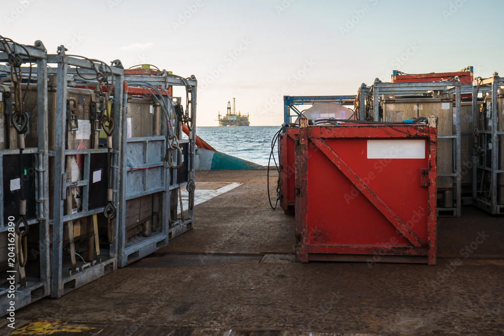 Marine cargo operations, offshore supply boat with containers and tanks ...
