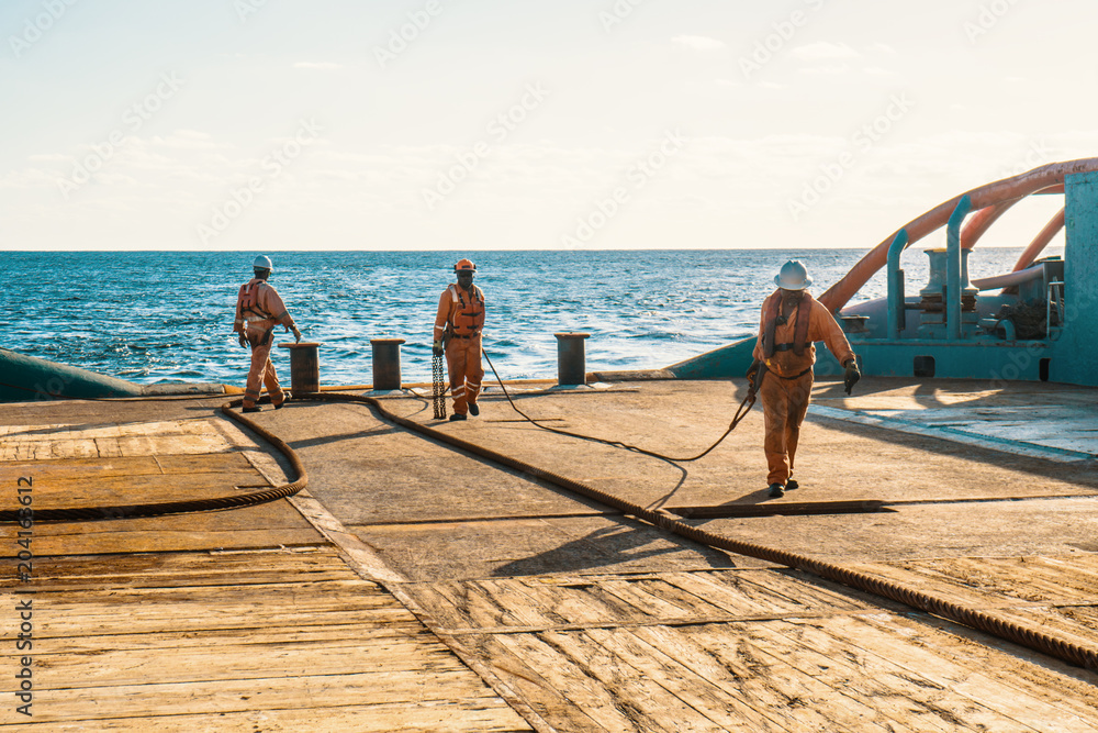 Anchor-handling Tug Supply AHTS vessel crew preparing vessel for static ...
