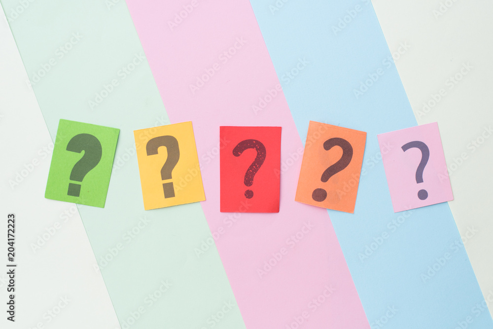 colorful paper with QUESTION MARK on multicolored pastel color ...