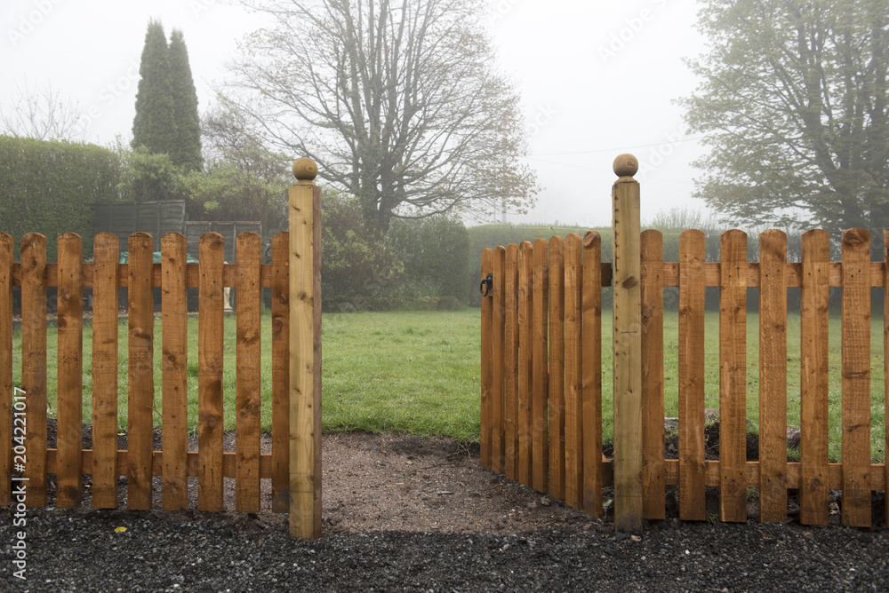 Open wooden gate and fence leading into a garden Stock Photo | Adobe Stock