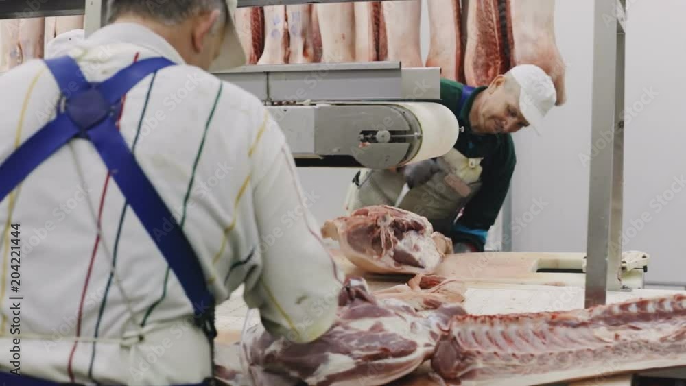 slaughterhouse workers cutting and sorting red meat closeup view ...