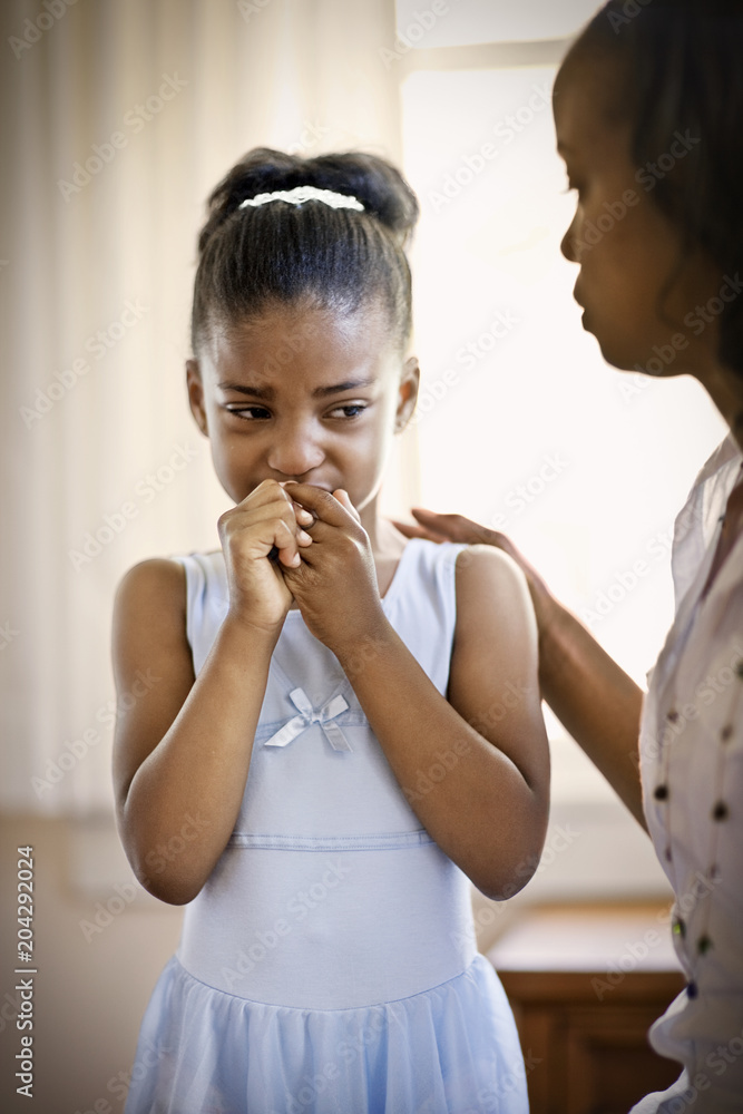 Sad little girl being comforted by her mother Stock Photo | Adobe Stock