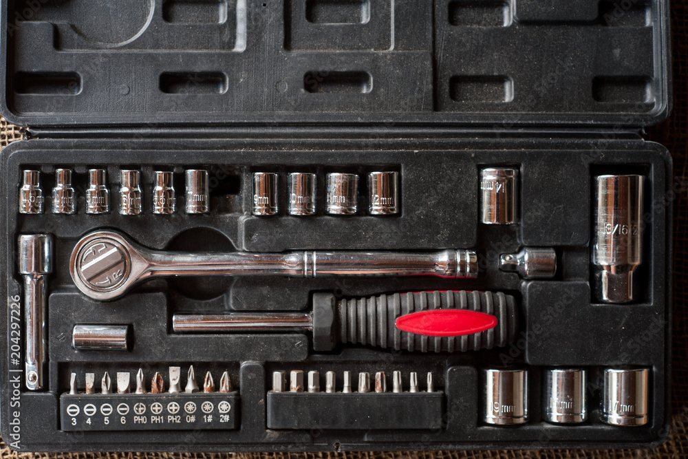 Set of tools with attachments and adapters for twisting nuts and bolts ...