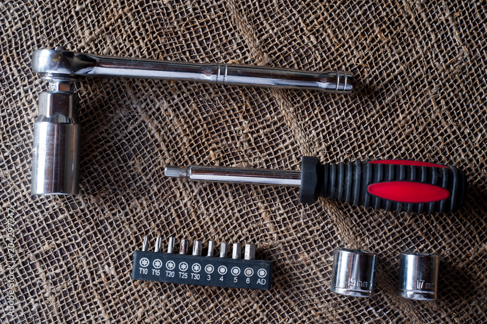 Set of tools with attachments and adapters for twisting nuts and bolts ...