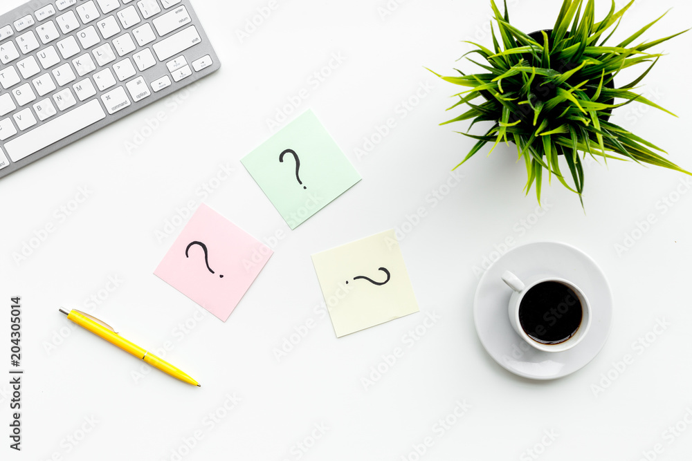 Question mark on sticky notes on office desk on white background top ...