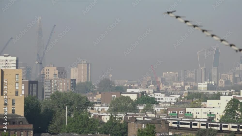 UK May 2018 - A train crosses a bridge in front of the Shard and the ...