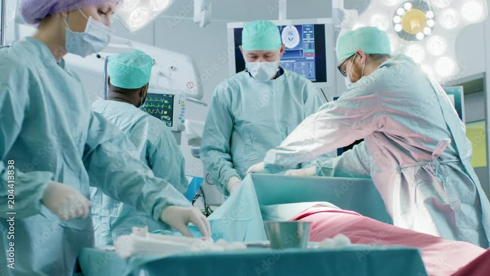 Diverse Team of Professional Surgeons Performing Invasive Surgery on a ...