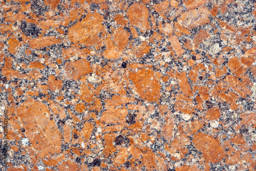 background, texture - variegated surface of polished granite slab with ...
