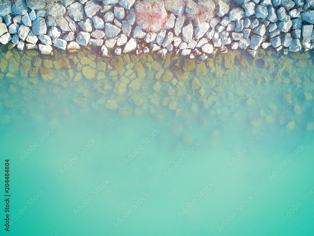 Beach top view with calm green spring water. Aerial leisure park marine ...
