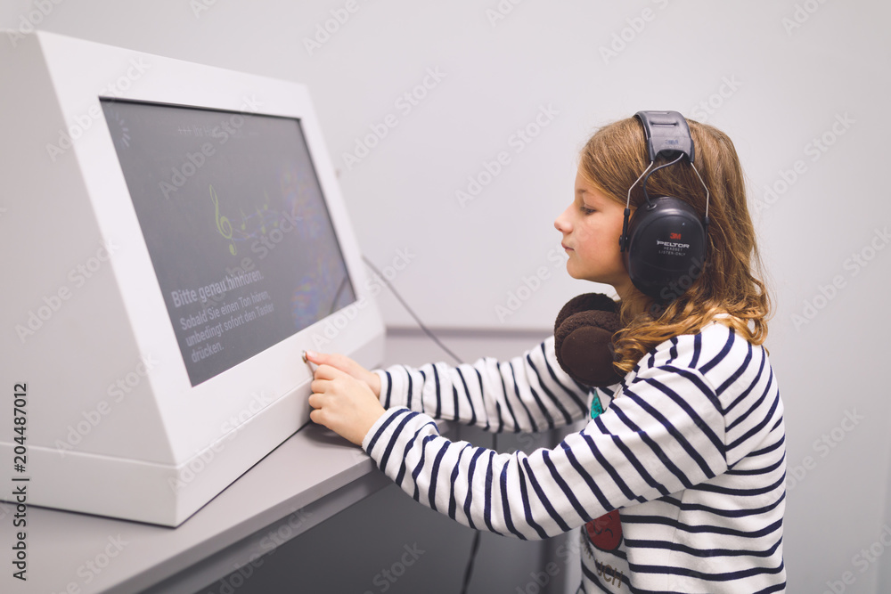 Young girl doing audiometry test wearing headphones Stock Photo | Adobe ...