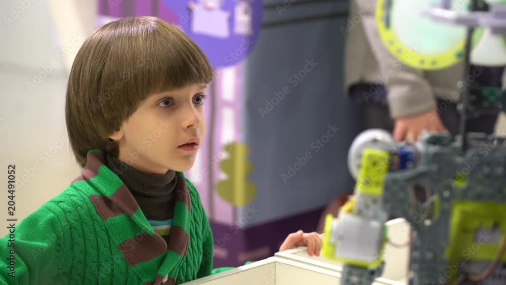Robot and child. Boy looking for robot. Kid boy watching robot. Boy ...