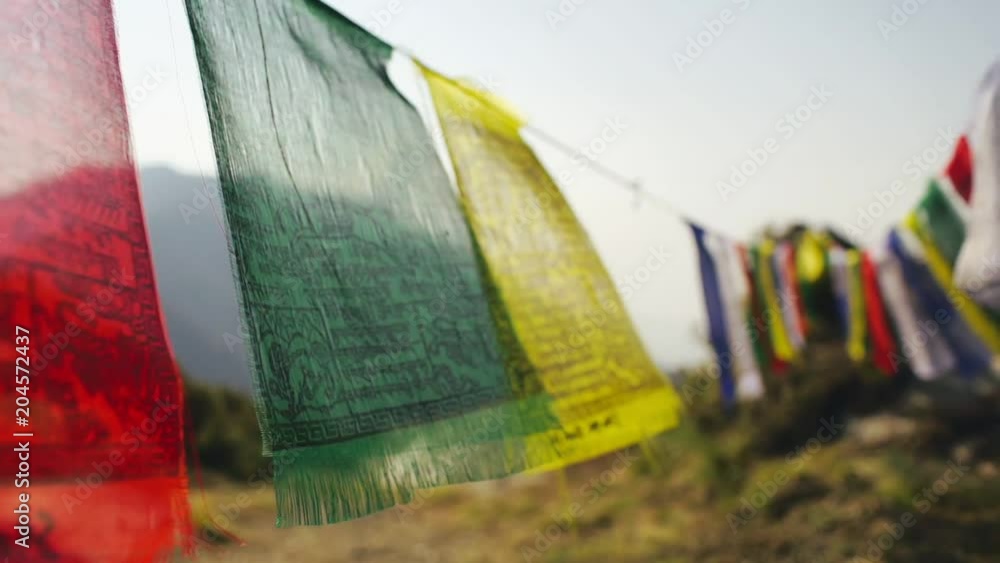 Close-up of many bright and various world flags waving at wind on ...