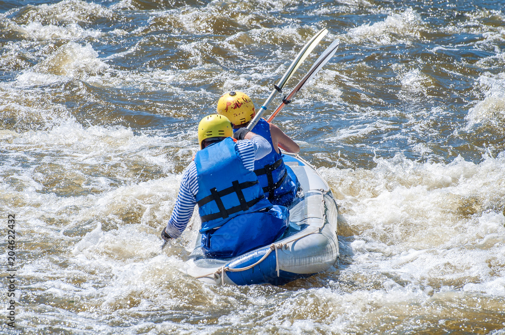 Rafting, kayaking. Two sportsmen in sports equipment are sailing on a ...