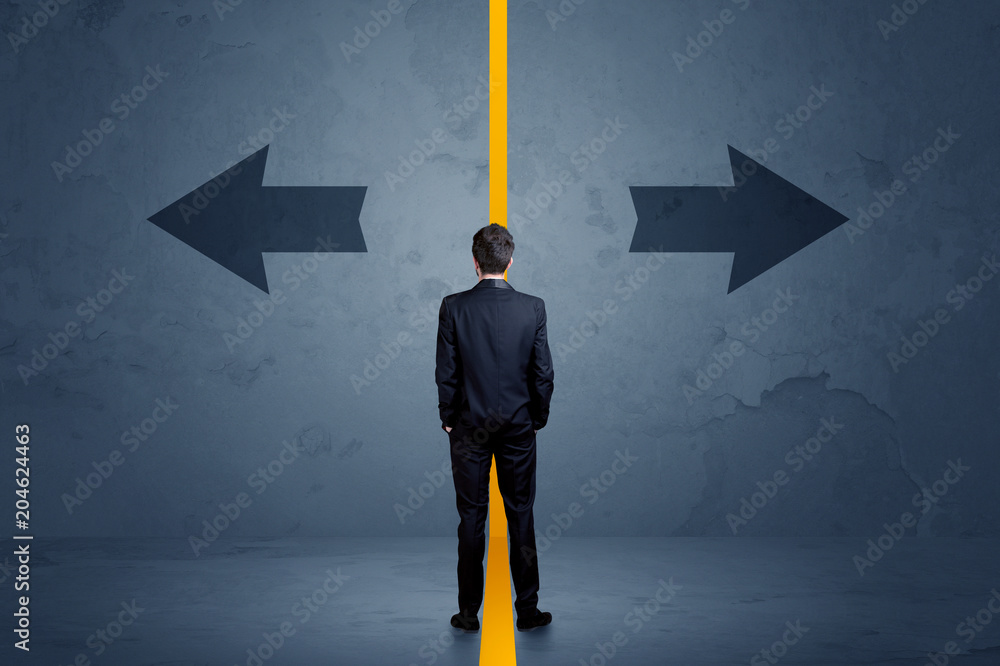 Business person choosing between two options separated by a yellow ...